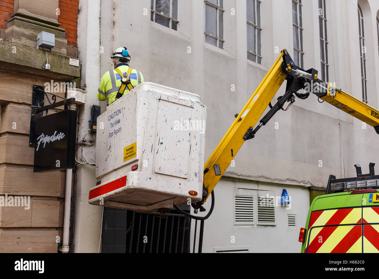 Lighting services engineer working out of truck-based cherry picker ...