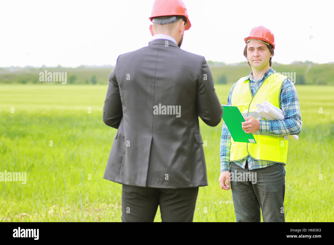 construction two man in the field Stock Photo - Alamy
