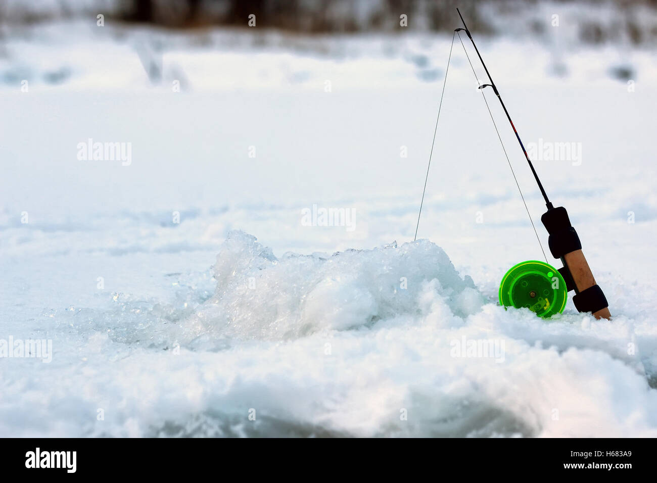 Little winter fishing rod ice Stock Photo - Alamy