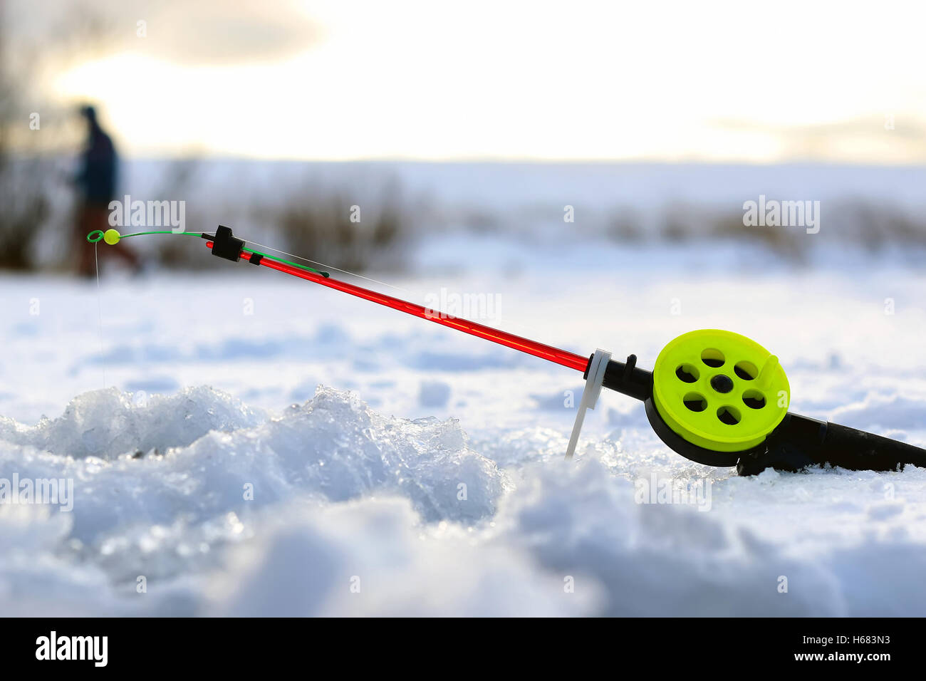 Little winter fishing rod ice Stock Photo - Alamy