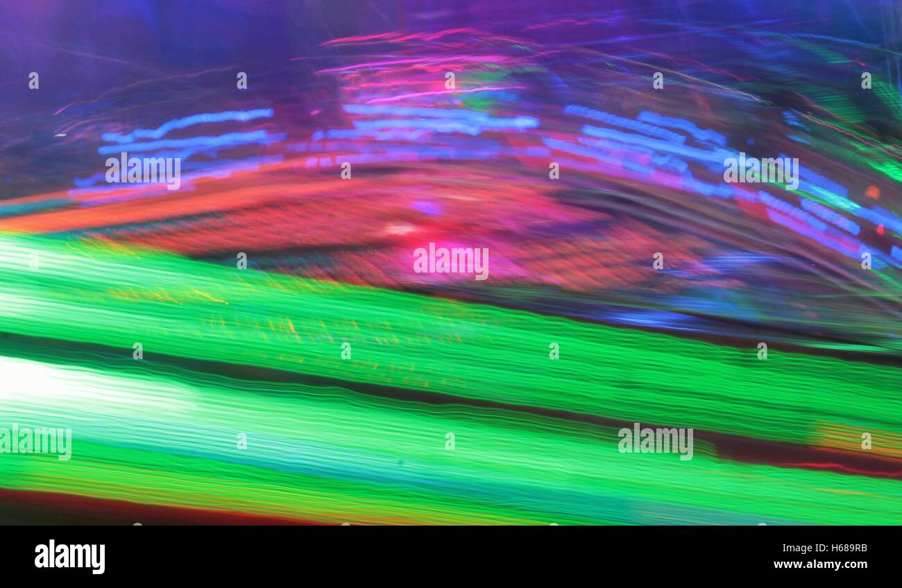 fairground funfair ride moving fast fair lights Night colours of the ...