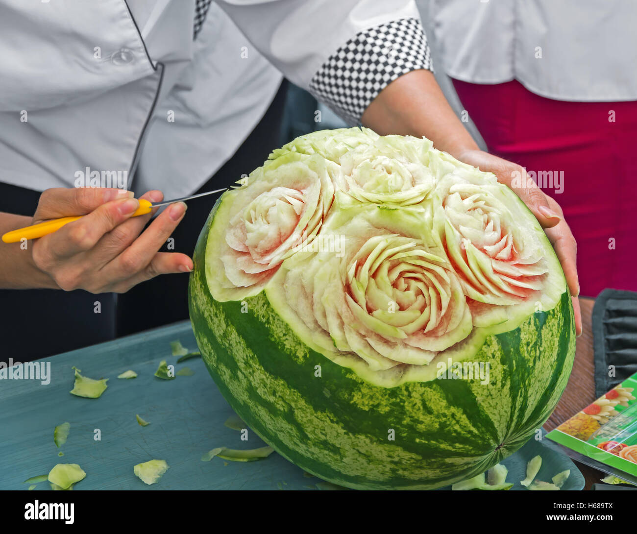A ripe vegetable is carved in form of flowers roses from watermelon ...
