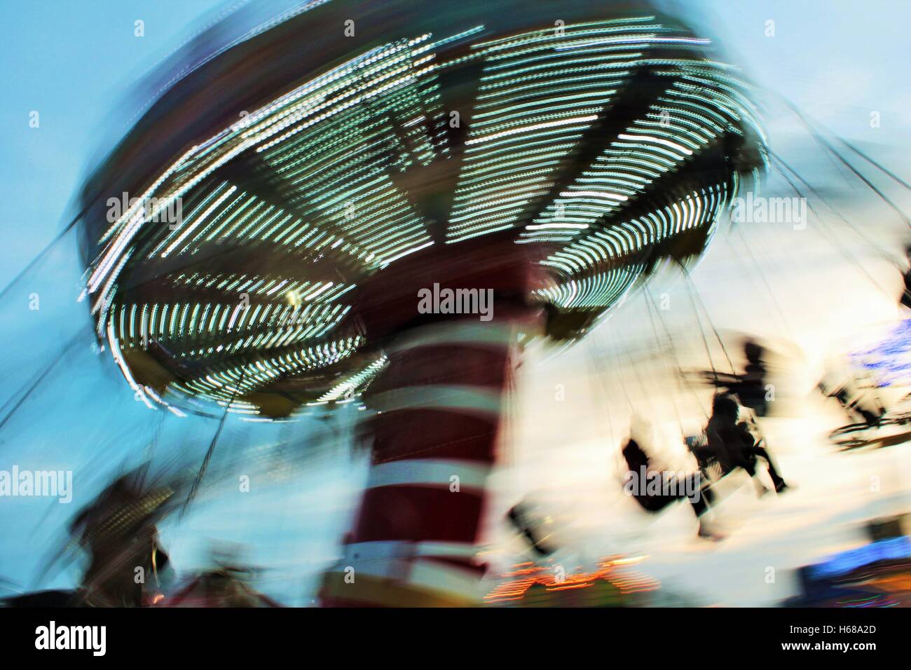 fairground funfair swing ride at dusk toned with retro vintage swings ...