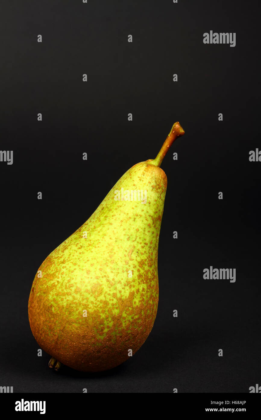 Ripe juicy conference pear isolated on a black background Stock Photo ...