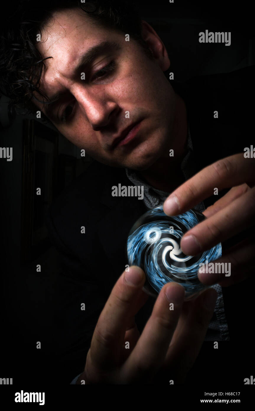 Hands holding magic crystal ball with smoky hypnosis spiral Stock Photo ...
