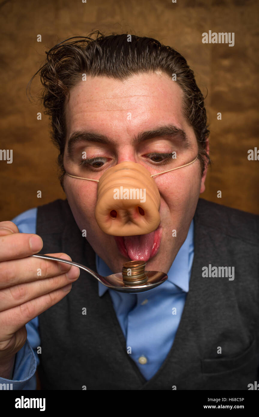 Silly pig man eating lose change for banking greed image Stock Photo ...