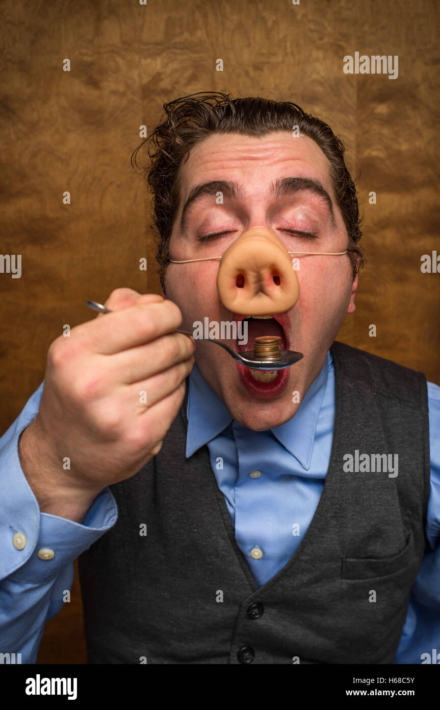 Silly pig man eating lose change for banking greed image Stock Photo ...