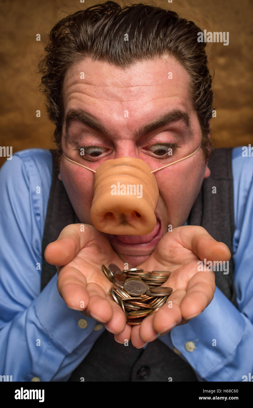 Silly pig man eating lose change for banking greed image Stock Photo ...