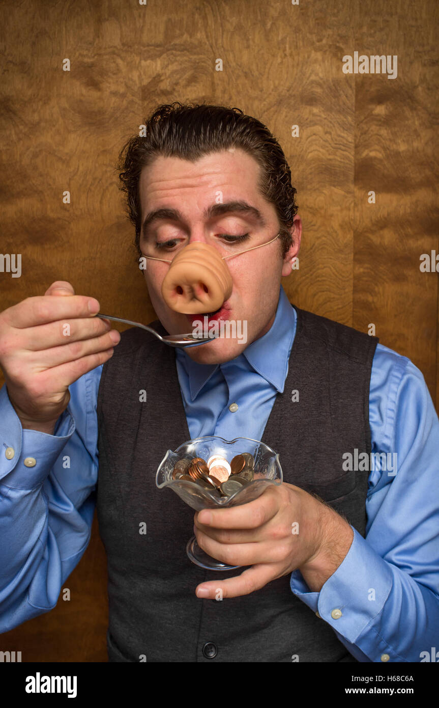 Silly pig man eating lose change for banking greed image Stock Photo ...