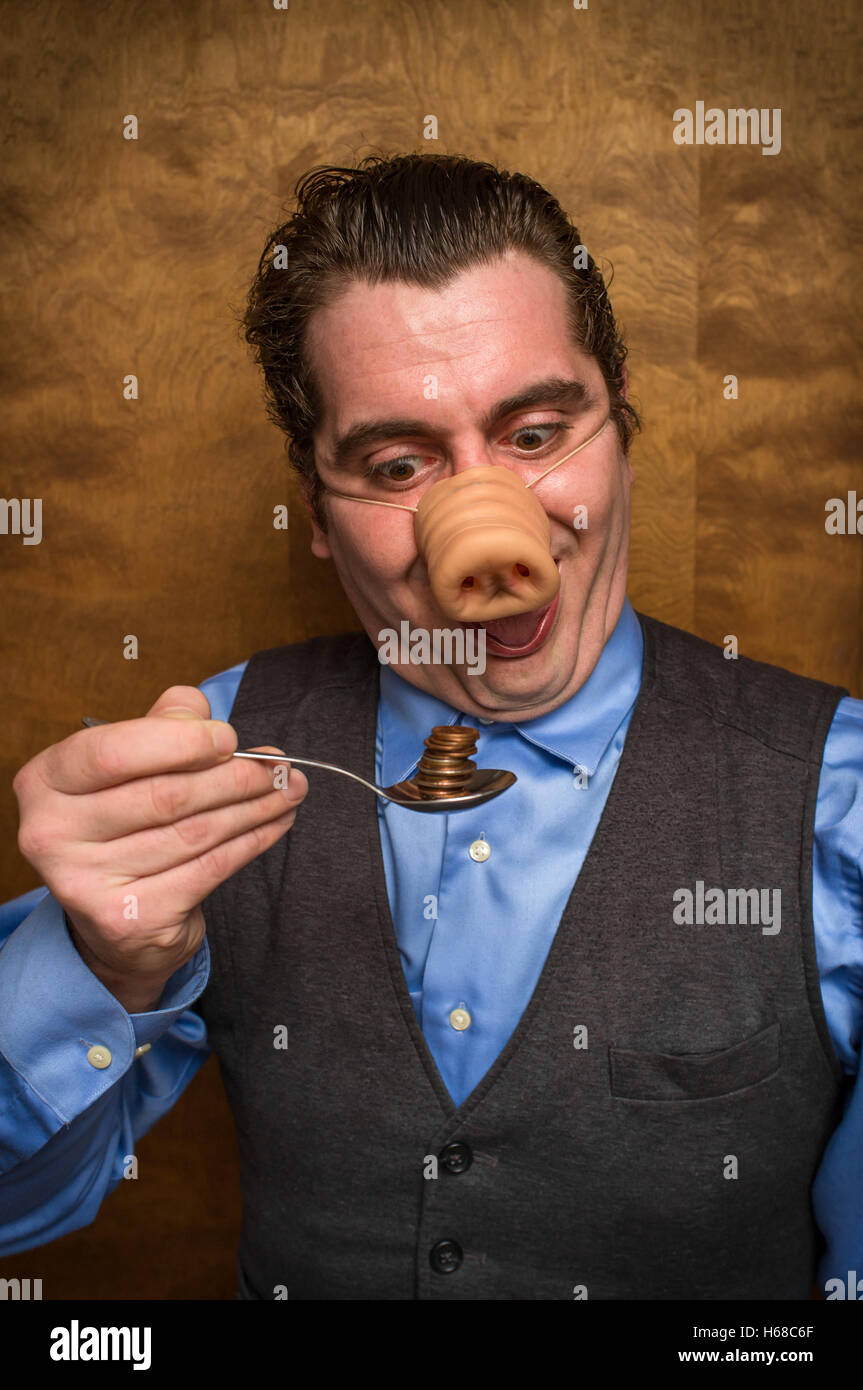 Silly pig man eating lose change for banking greed image Stock Photo ...