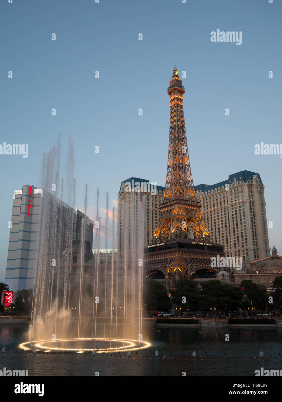 Bellagio Hotel and Casino fountains light show with Paris Las Vegas Eiffel Tower in background ...