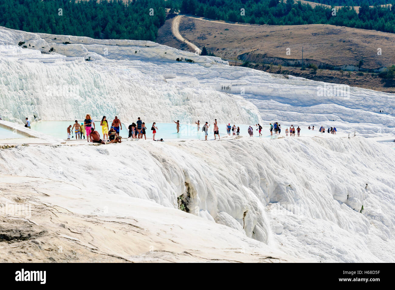 Visitors bathing in the thermal springs pools water at Pamakkule ...