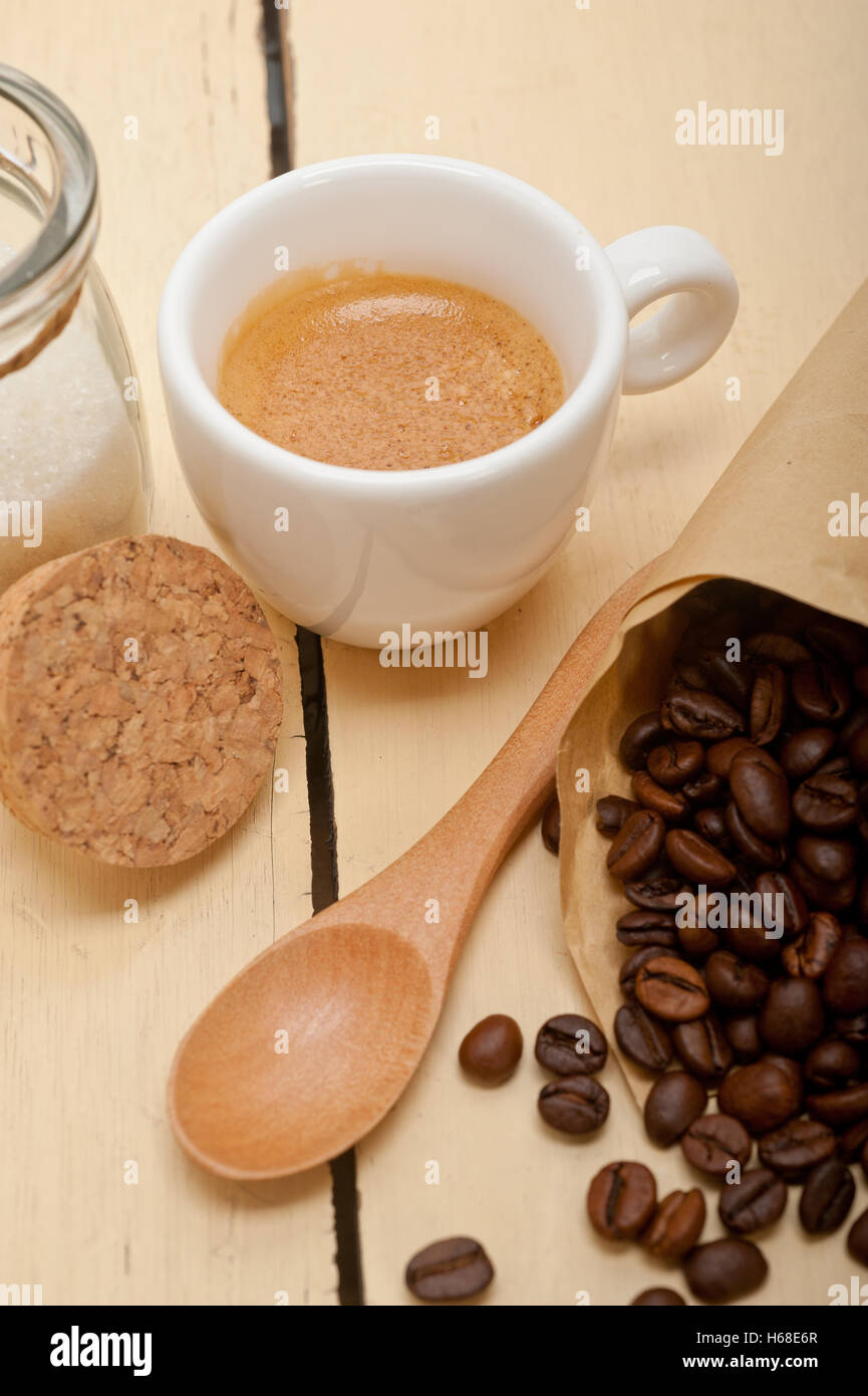 espresso coffee and beans on a paper cone cornucopia over white ...