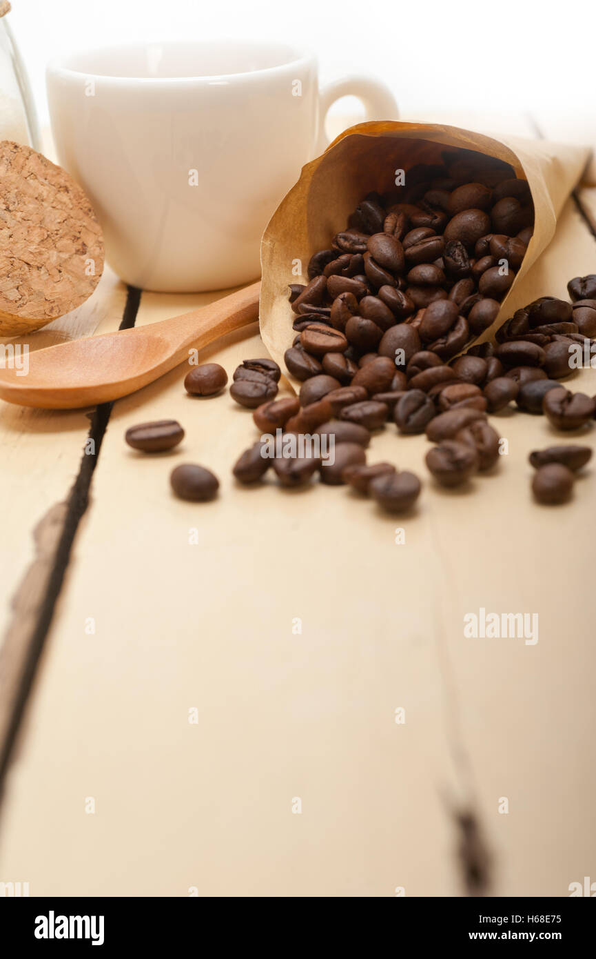 espresso coffee and beans on a paper cone cornucopia over white ...