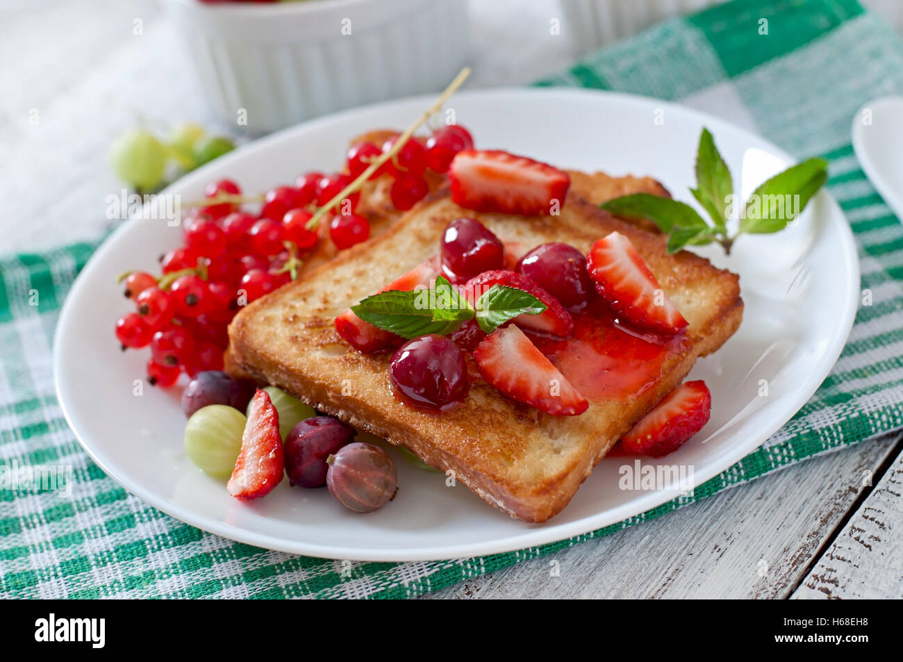 French toast with berries and jam for breakfast Stock Photo - Alamy