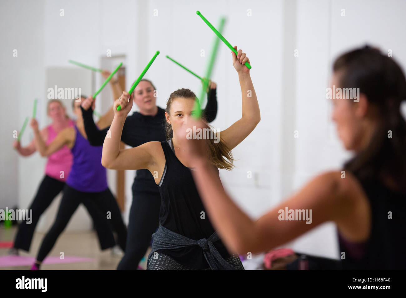 Women participating in POUND fitness class, hour long workout drumming ...