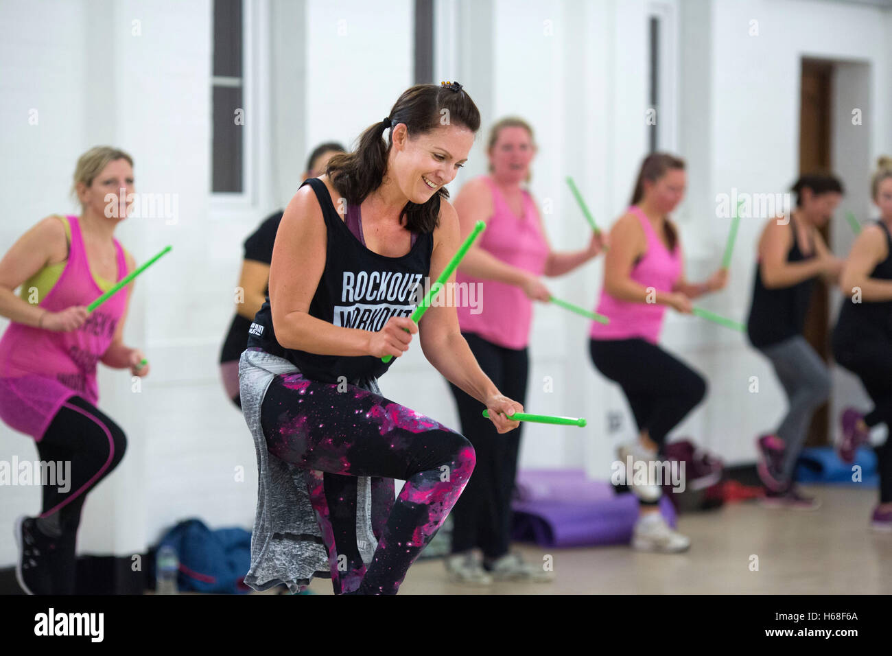 Women participating in POUND fitness class, hour long workout drumming ...