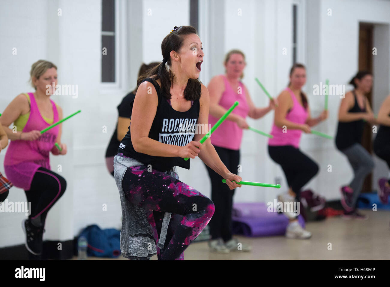 Women participating in POUND fitness class, hour long workout drumming ...