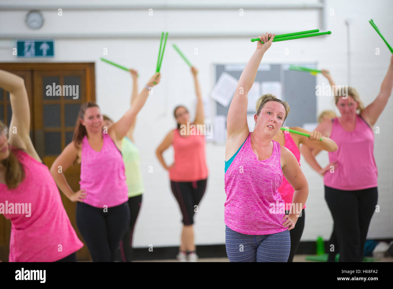 Women participating in POUND fitness class, hour long workout drumming ...