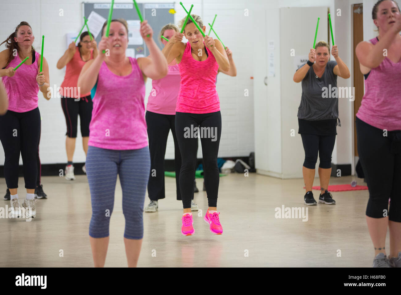 Women participating in POUND fitness class, hour long workout drumming ...
