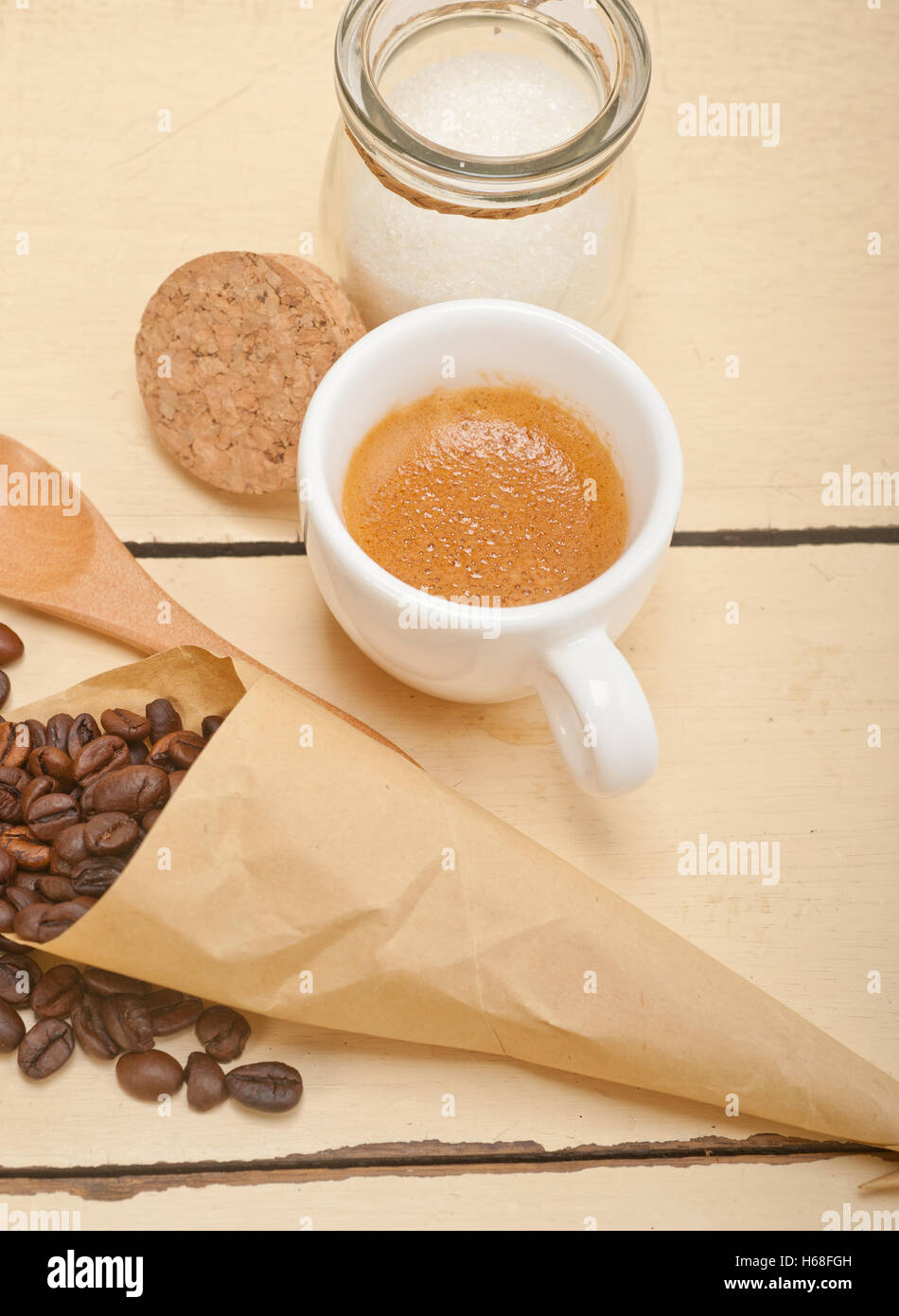 espresso coffee and beans on a paper cone cornucopia over white ...