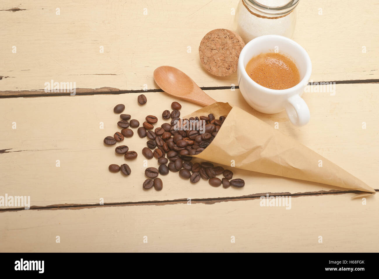 espresso coffee and beans on a paper cone cornucopia over white ...