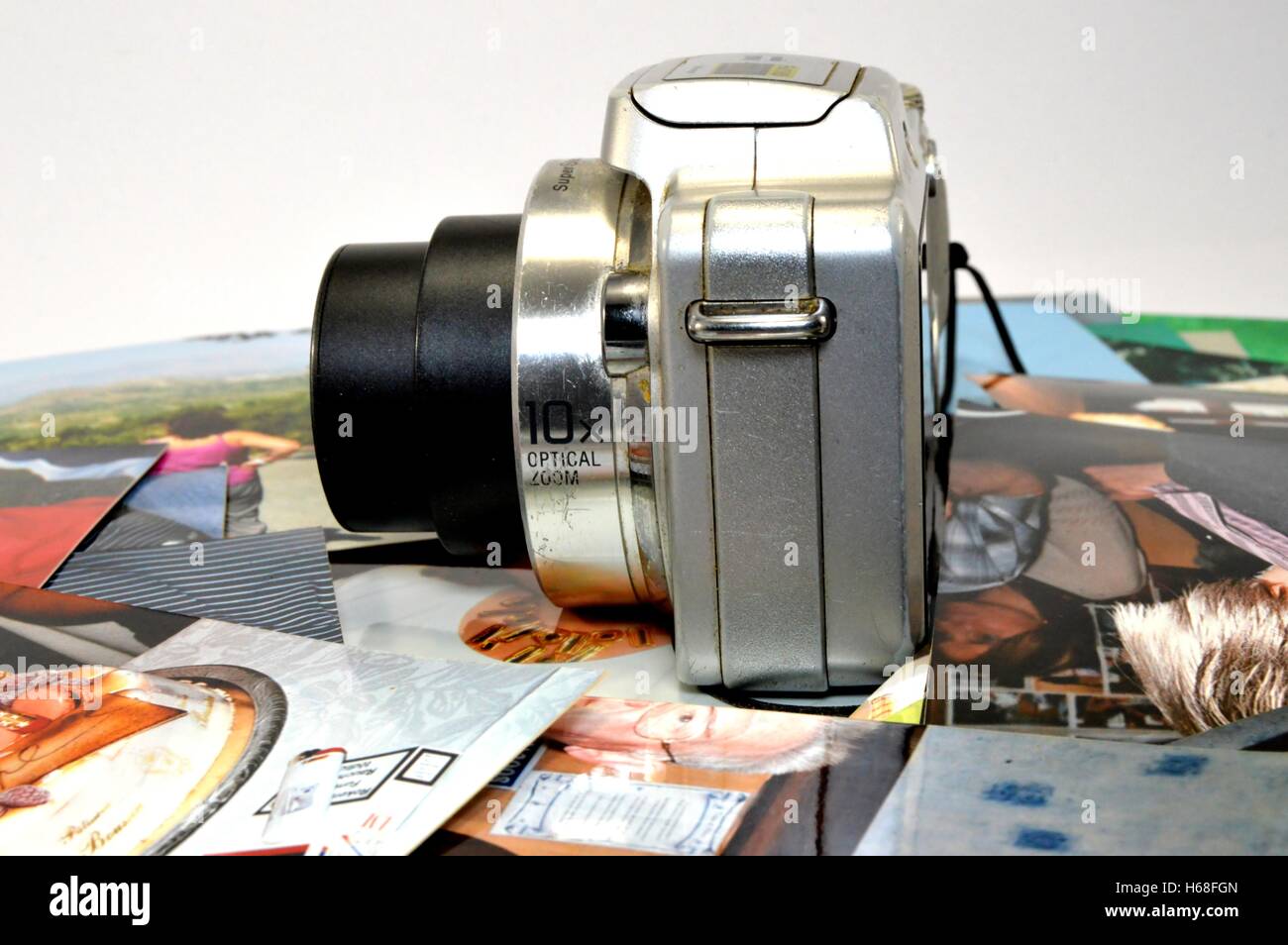 Old woman digital camera put on a heap of photos Stock Photo - Alamy