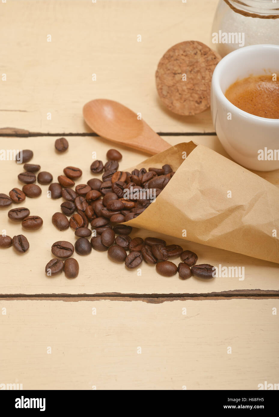 espresso coffee and beans on a paper cone cornucopia over white ...