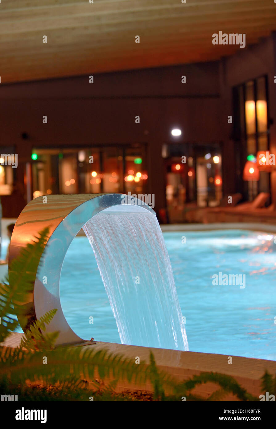 Relaxation pool in spa with waterfall Stock Photo - Alamy