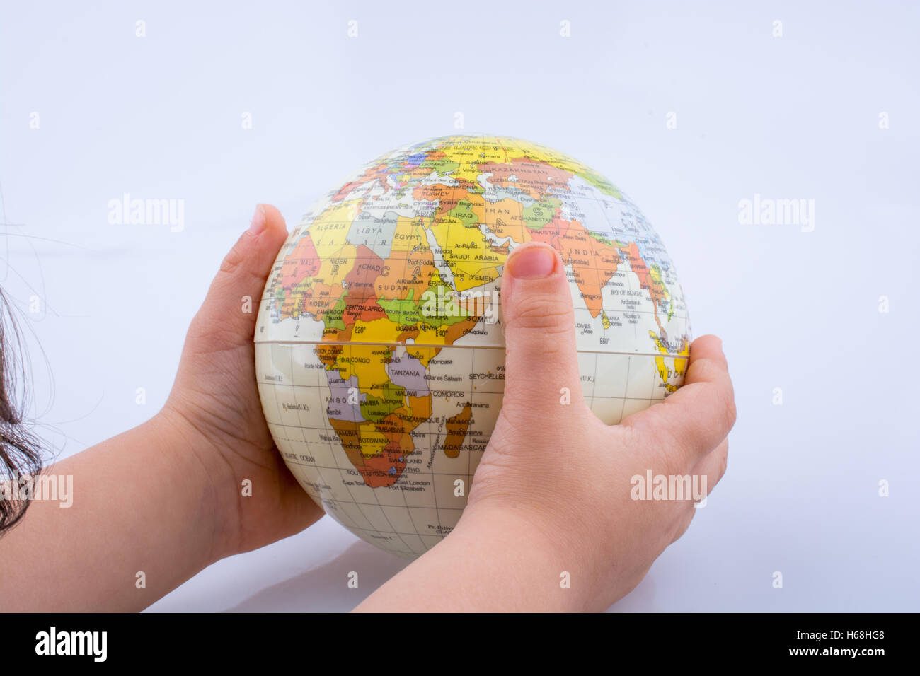 Child holding a globe in his hand on a white background Stock Photo - Alamy