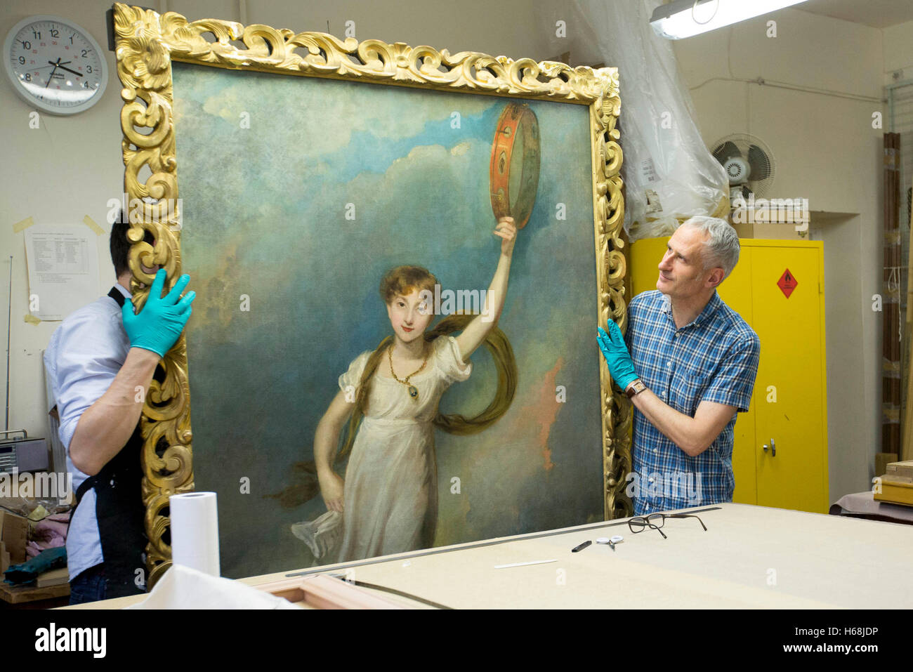 Conservators carry a newly reframed portrait of Horatia Nelson, the ...
