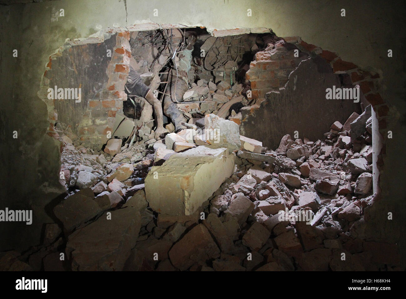 The body of a garment worker is seen amongst the rubble of the ...