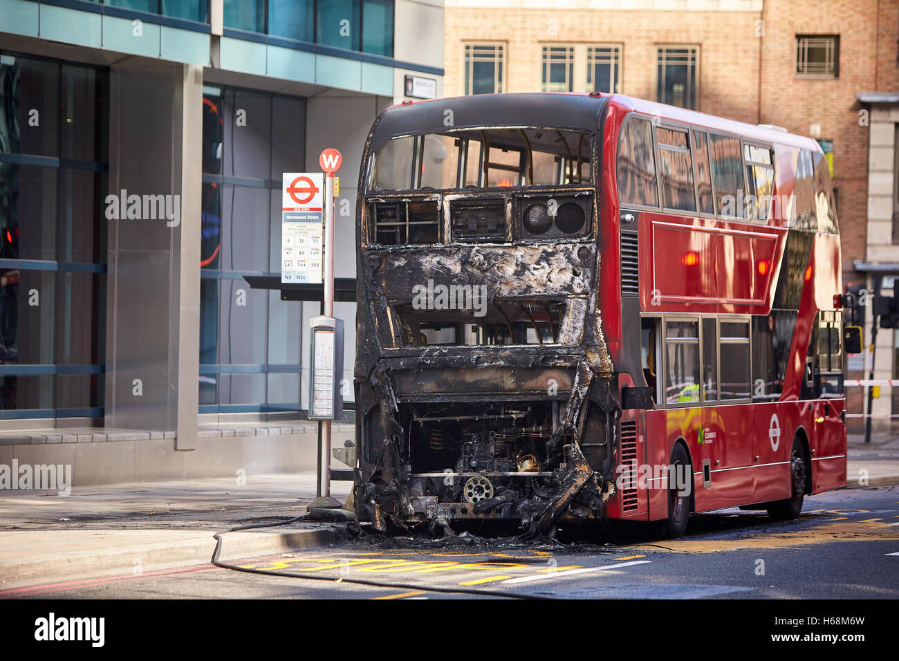 A fire-damaged bus in Bishopsgate, London Stock Photo - Alamy