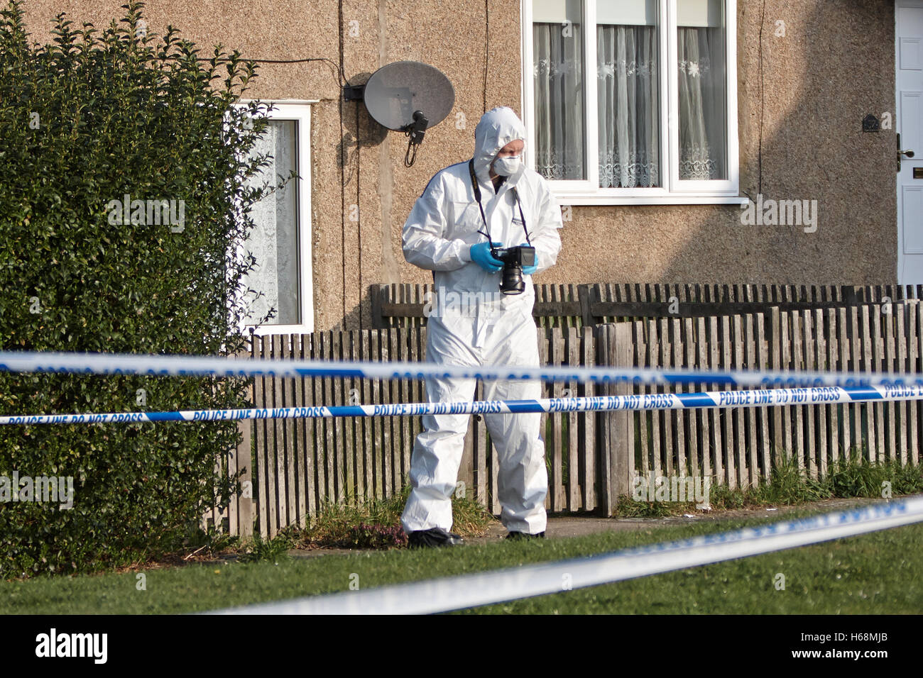 A forensic officer investigates the scene of an unexplained death in ...