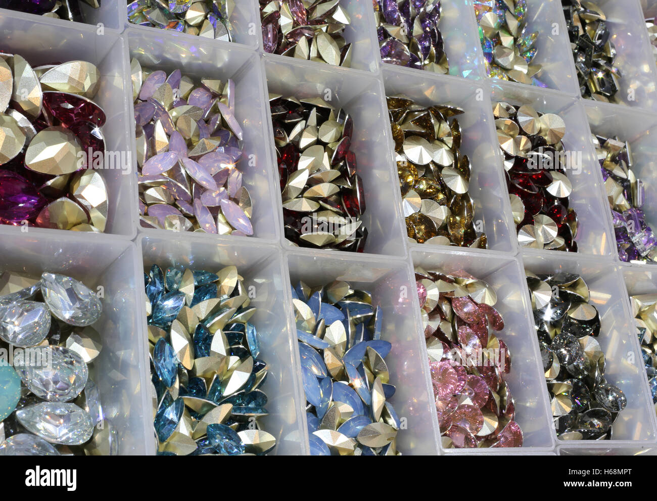 plastic boxes with tiaras and stones for decoration and necklaces for ...