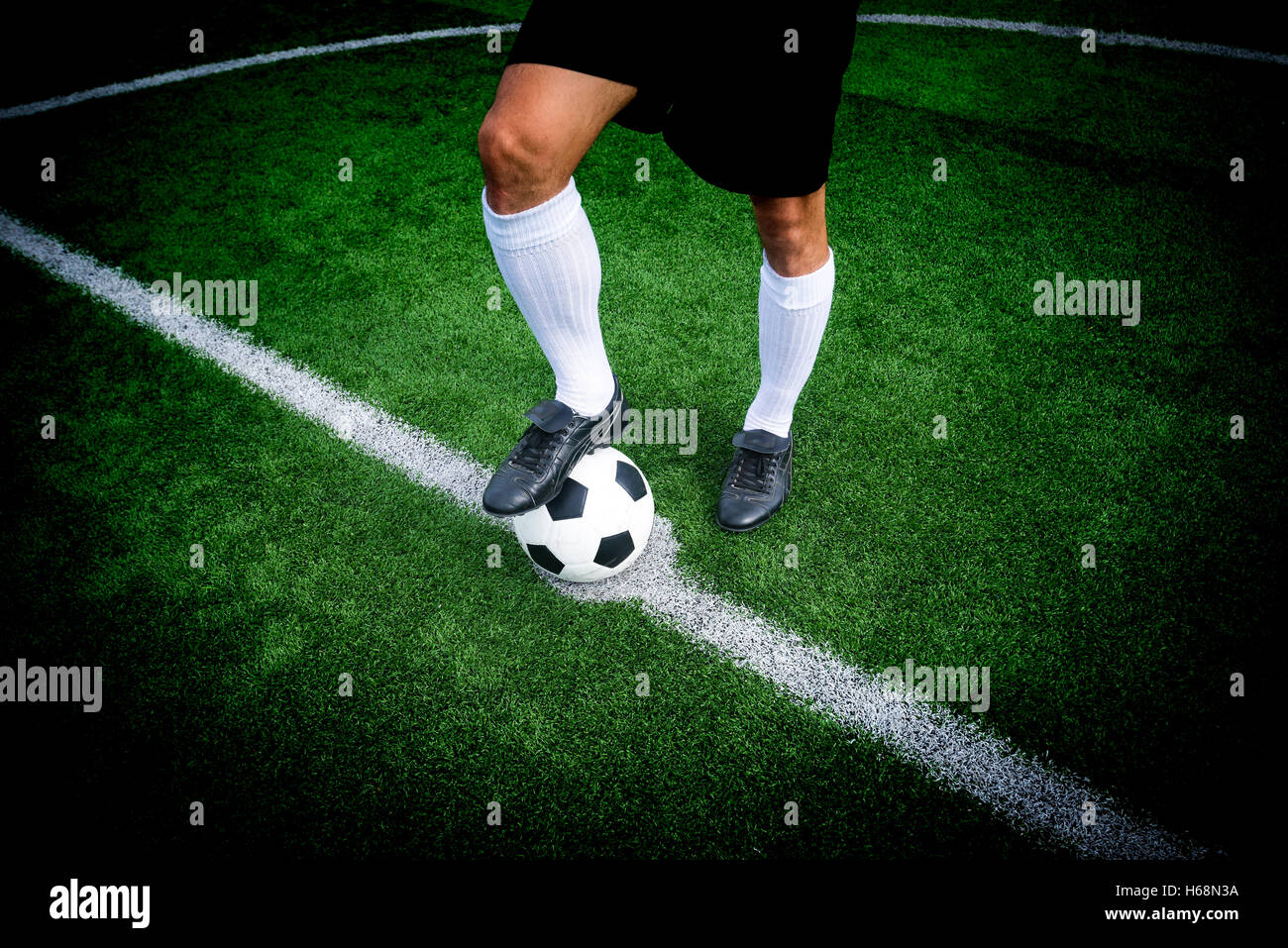 Soccer player ready to play at start kick off point in soccer field ...