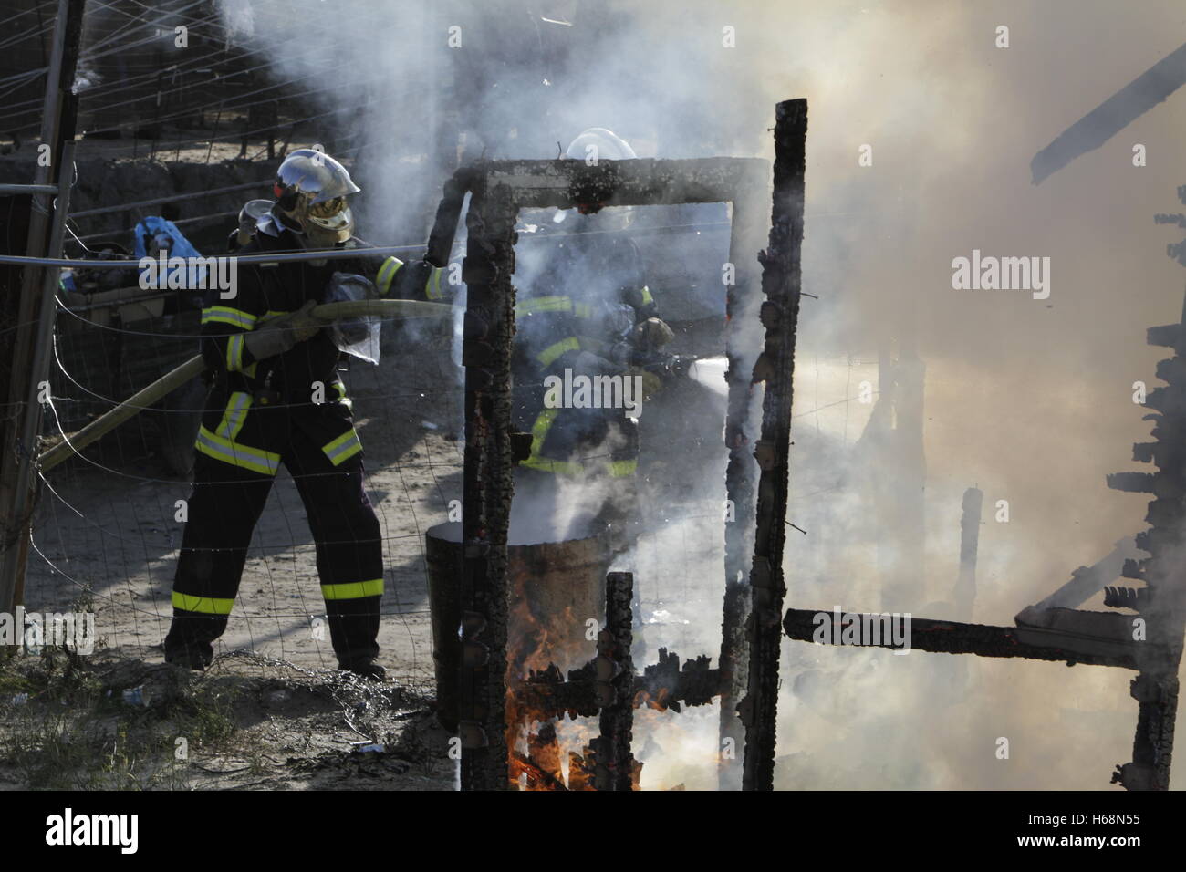 Calais, France. 25th Oct, 2016. A fire officer from the Calais Fire ...