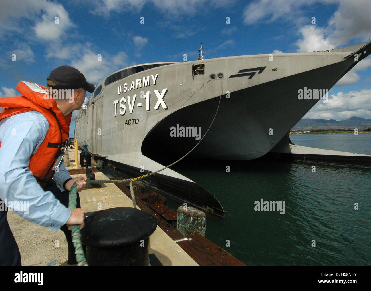 A Navy Petty Officer casts off a mooring line as the U.S. Army's ...