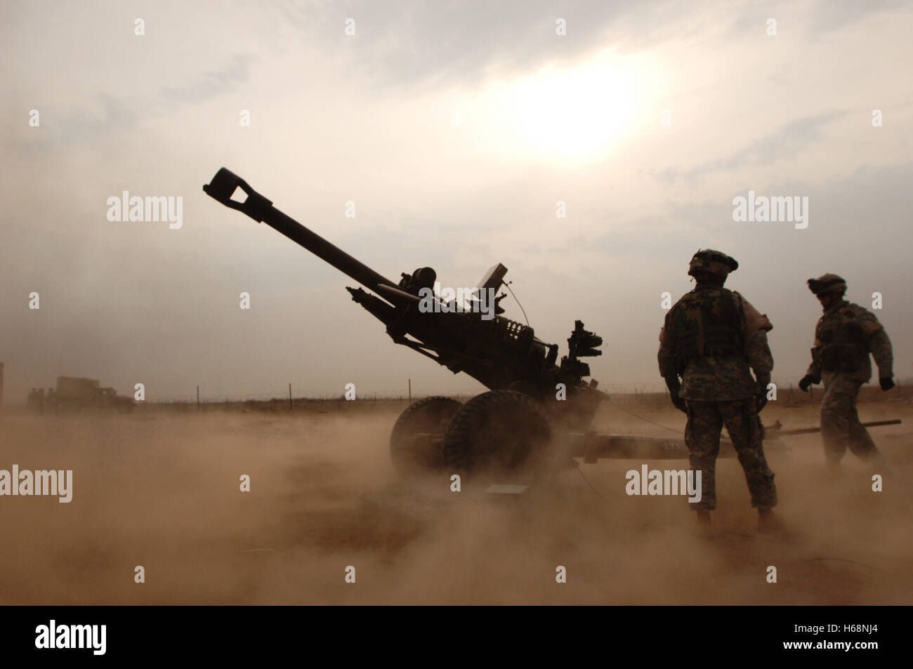 U.S. Army soldiers train on firing points with an M119 Howitzer outside ...