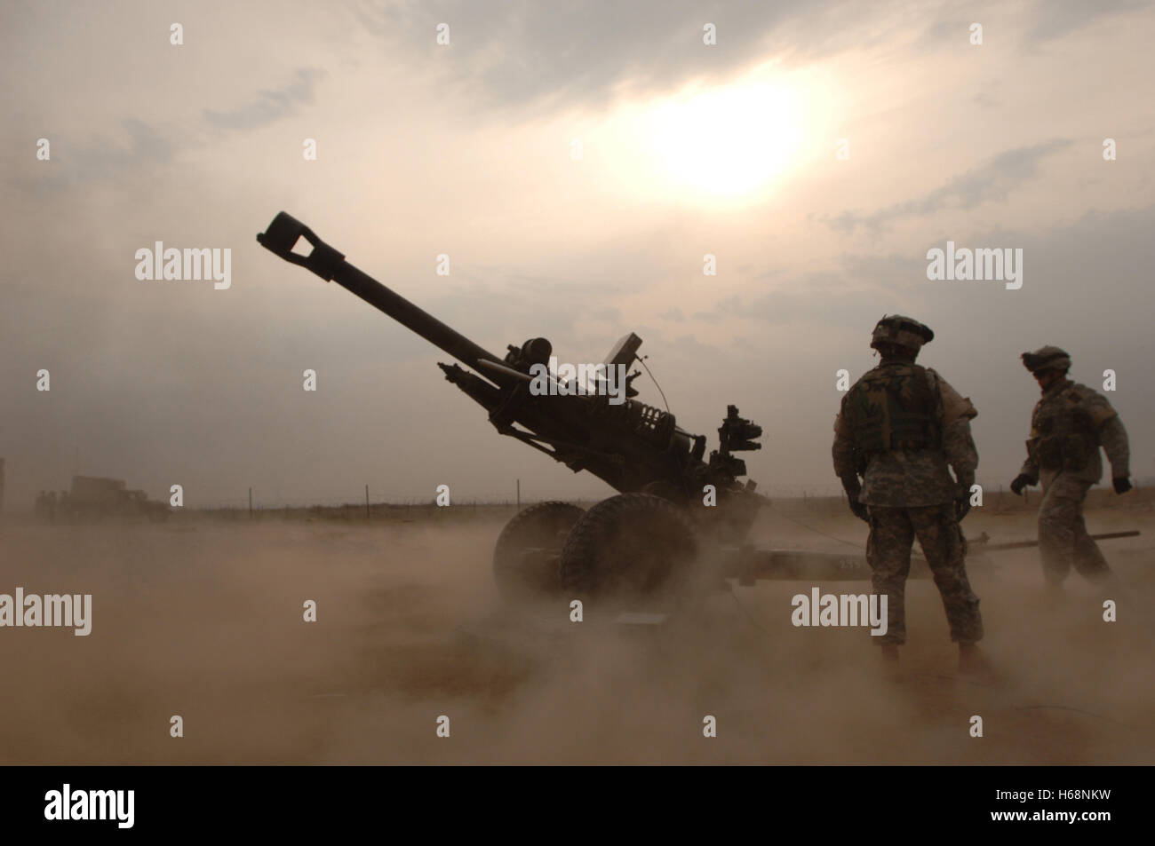 U.S. Army soldiers train on firing points with an M119 Howitzer outside ...