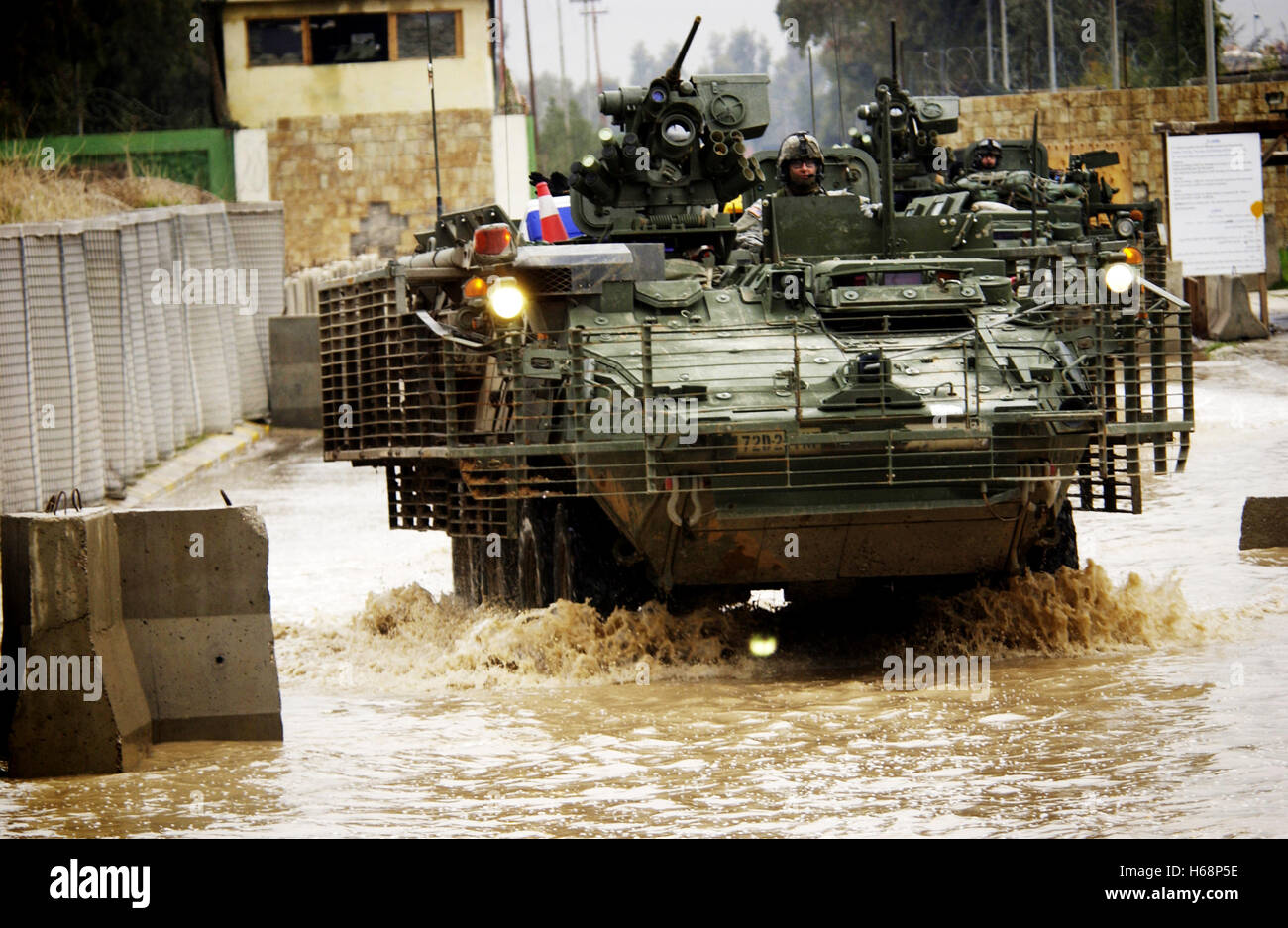 U.S. Army Stryker combat vehicles ford a flooded street as they patrol ...