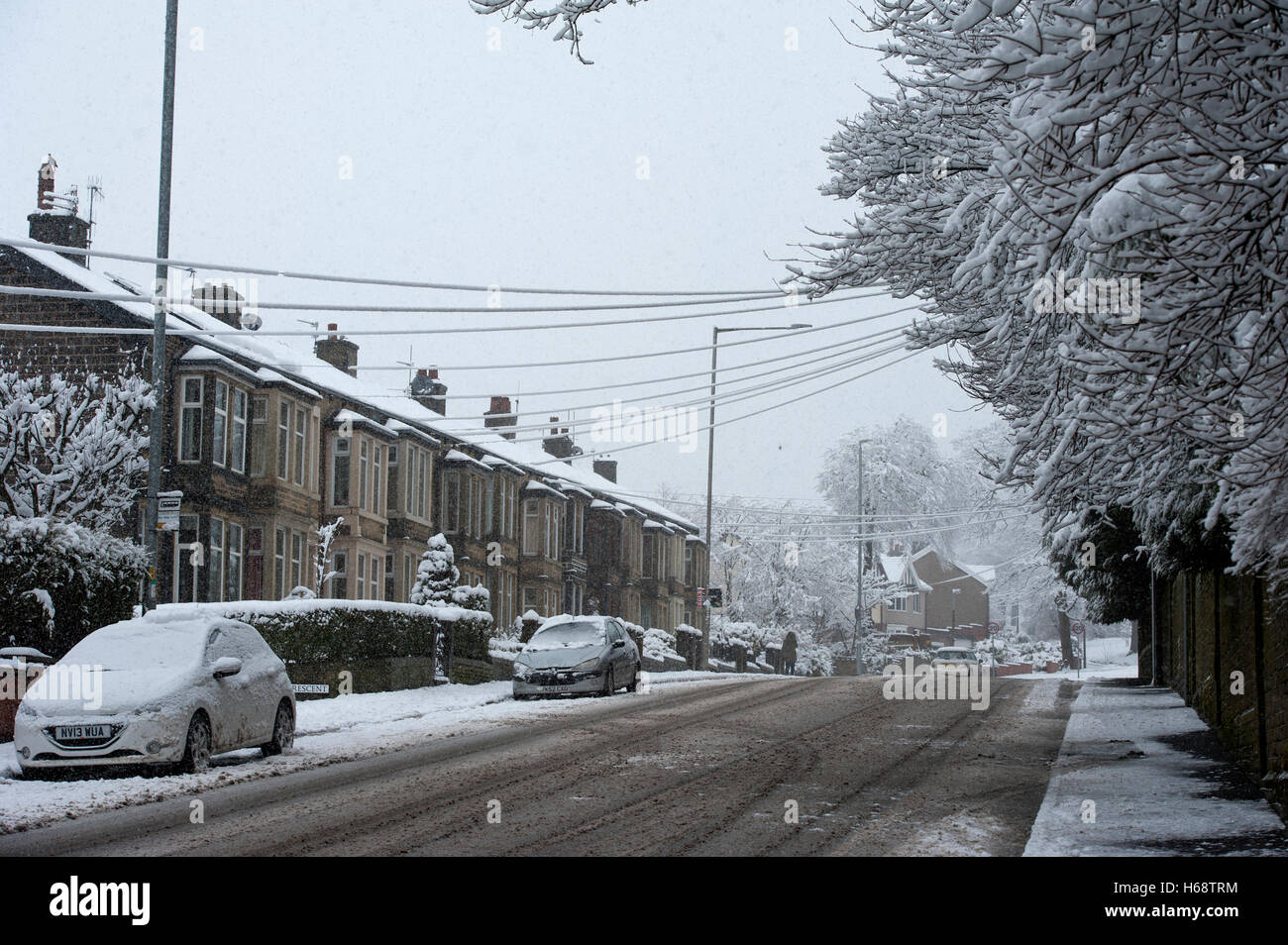 Northern winter street covered with snow, Road and cars with snow cover ...