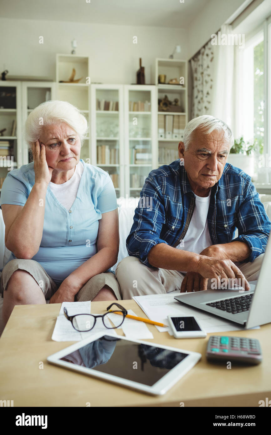 Worried senior couple using laptop Stock Photo - Alamy