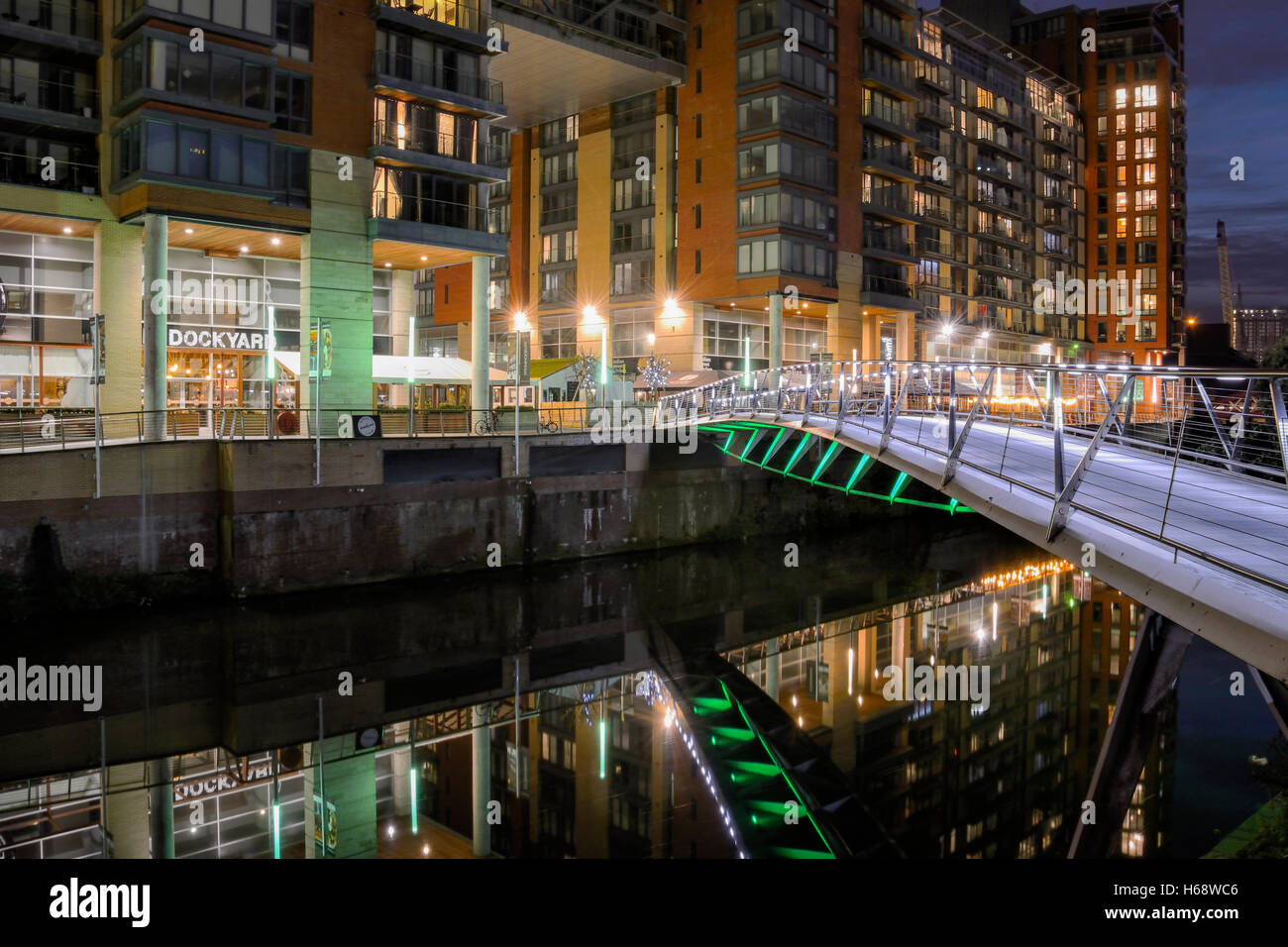 Illuminated footbridge crossing the River Irwell joining Spinningfields ...