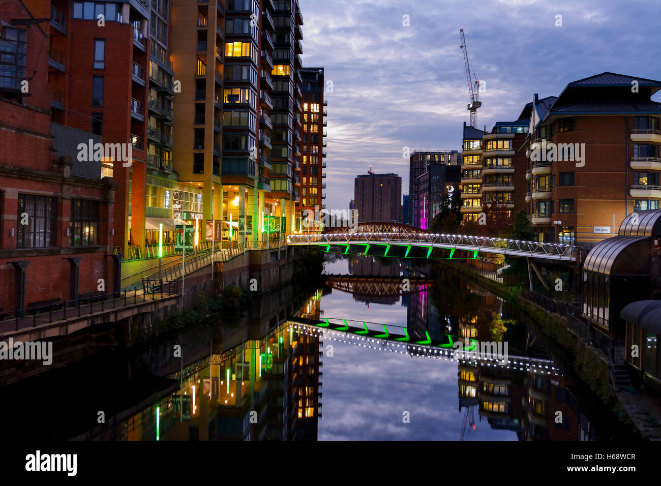 Illuminated footbridge crossing the River Irwell joining Spinningfields ...
