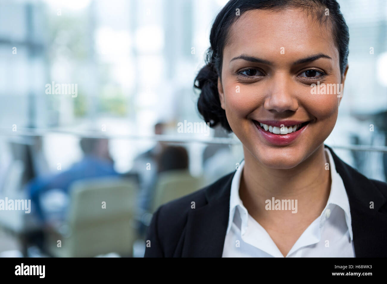 Smiling businesswoman in office Stock Photo - Alamy