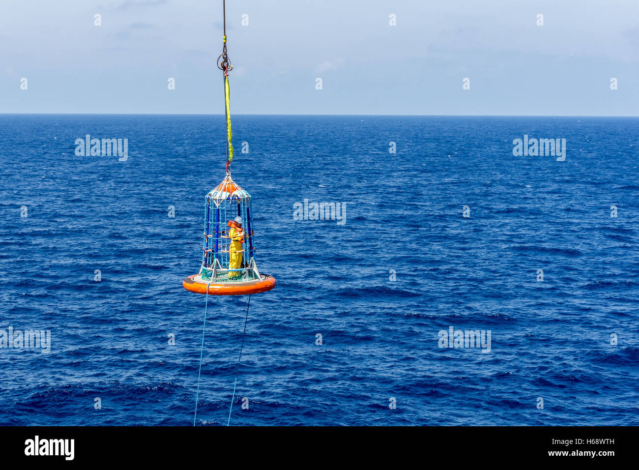 Offshore worker being lifted using personal transfer basket from ...