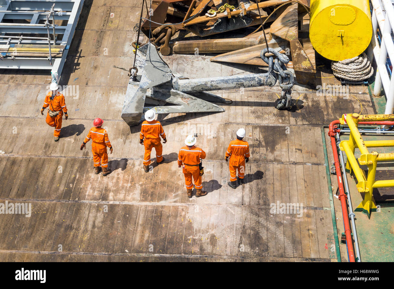 Offshore crews handling and lifting anchor four deployment on ...