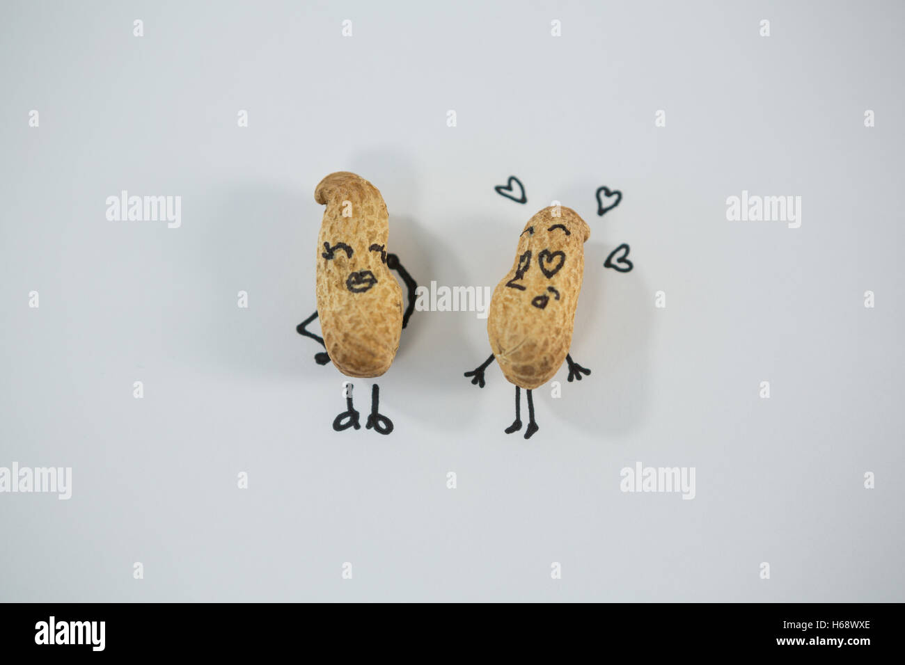 Peanut figurine as a couple standing together Stock Photo - Alamy