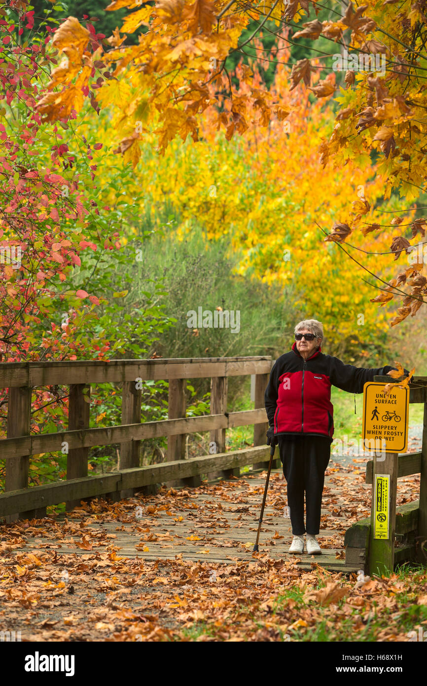 Elderly woman with cane resting along Galloping Goose trail-Metchosin ...